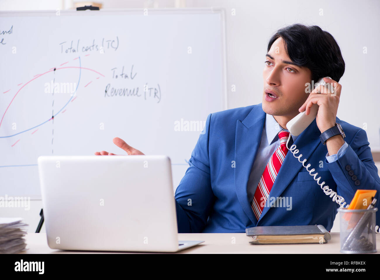 Busy businessman explaining business charts Stock Photo - Alamy