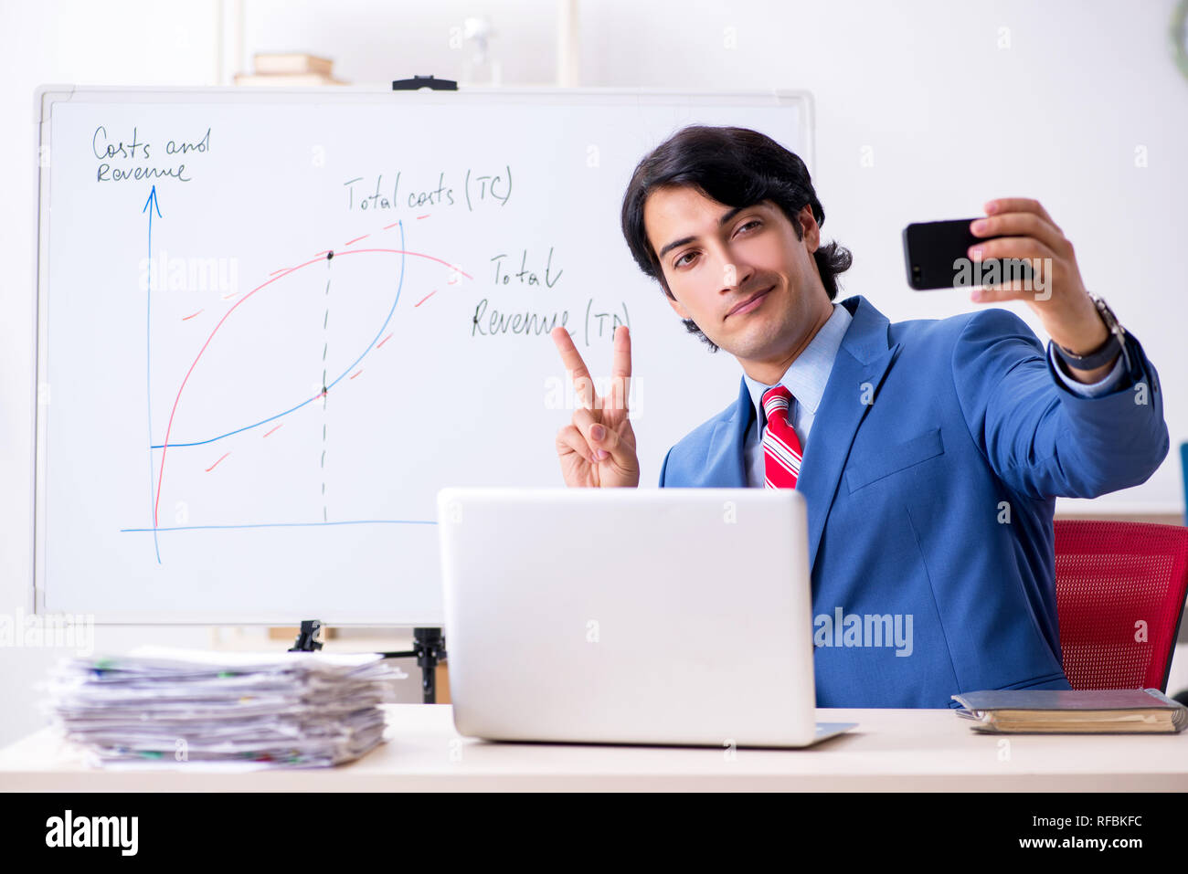 Busy businessman explaining business charts Stock Photo - Alamy