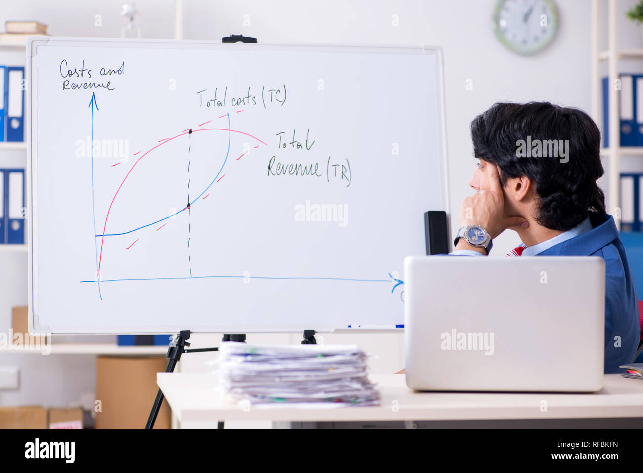 Busy businessman explaining business charts Stock Photo - Alamy