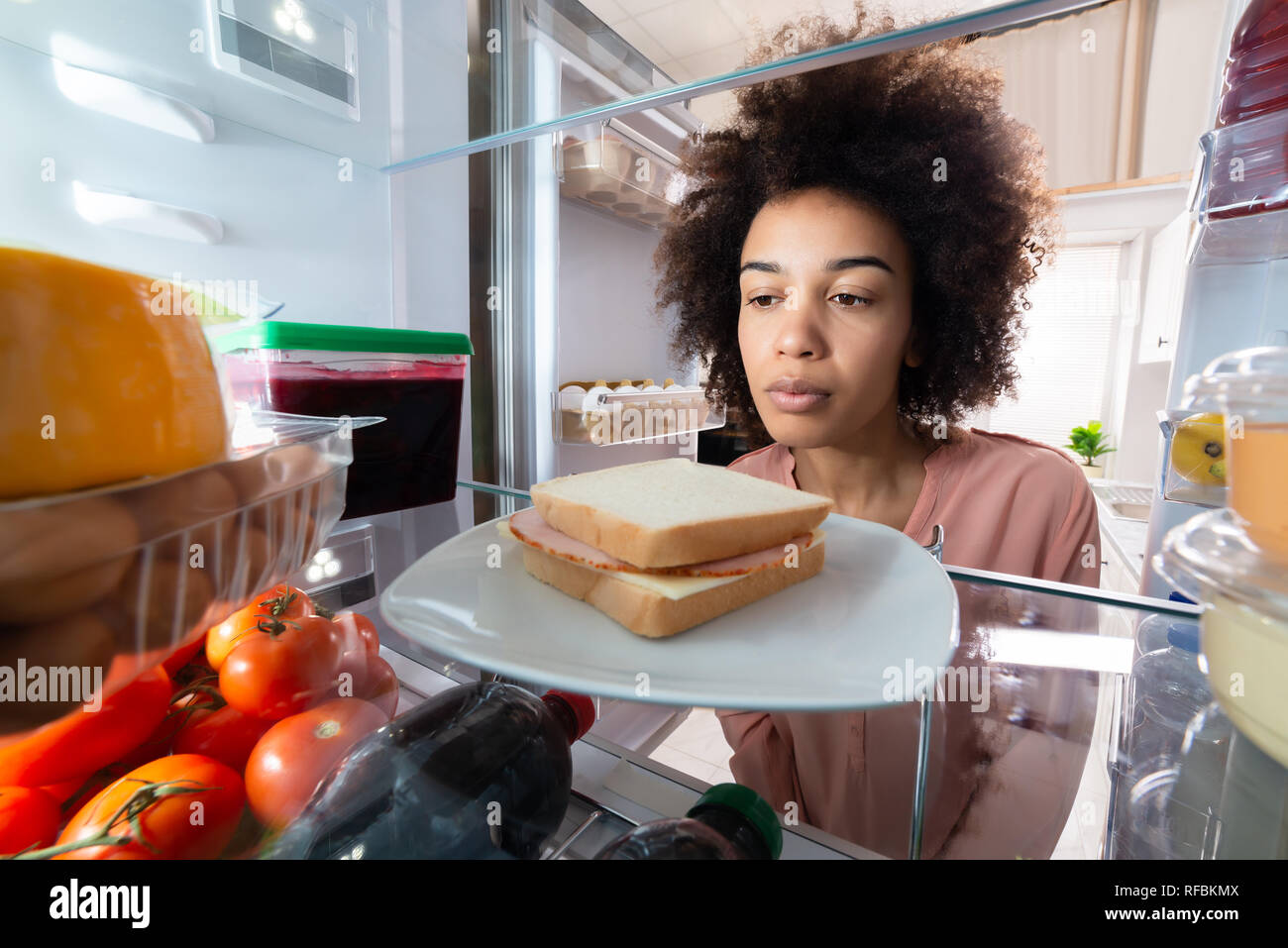 Close-up Of A African Young Woman Searching For Food In An Open ...