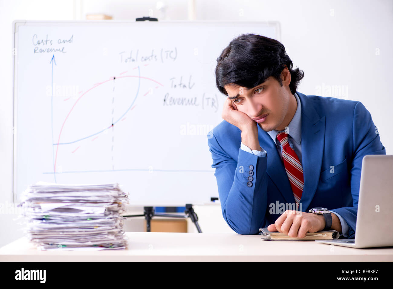 Busy businessman explaining business charts Stock Photo - Alamy