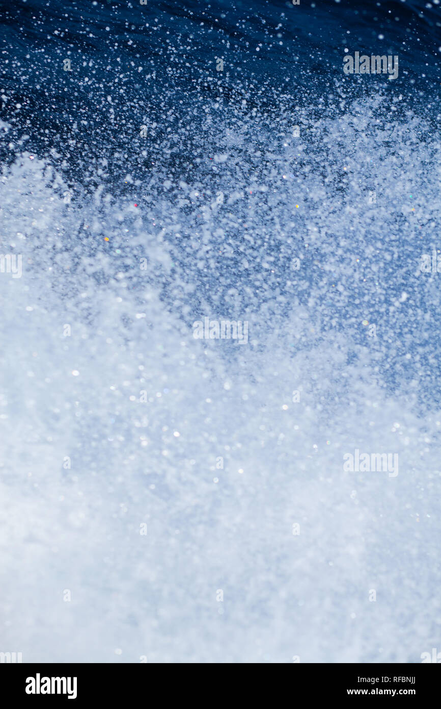Water spray from wake of speeding boat at sea Stock Photo - Alamy