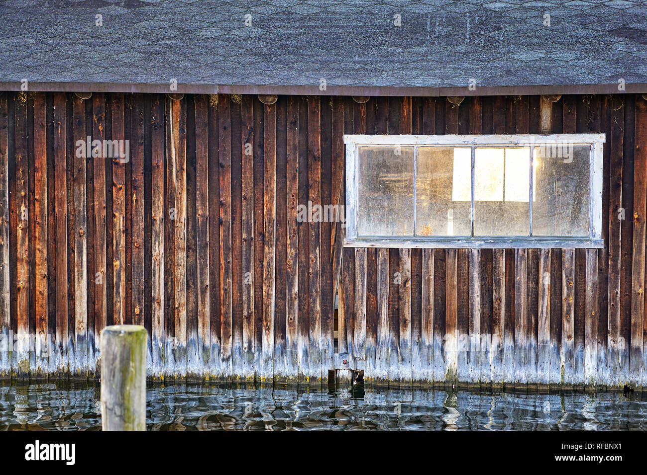 Old wooden boathouse with window Stock Photo - Alamy