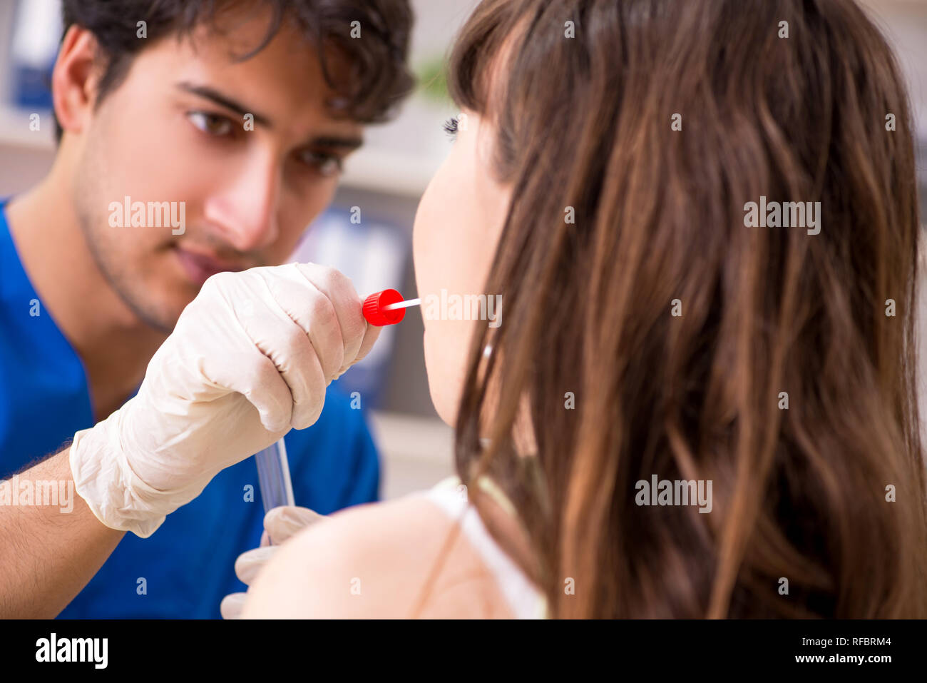 Doctor getting saliva test sample in clinic hospital Stock Photo - Alamy