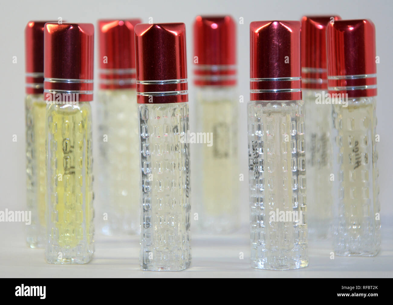 Eight bottles of liquid made of transparent glass with a decorative cap ...