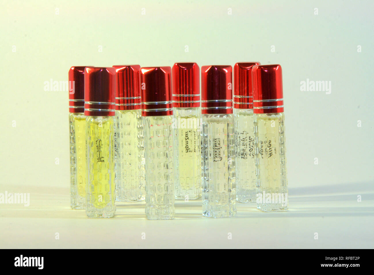 Eight bottles of liquid made of transparent glass with a decorative cap ...