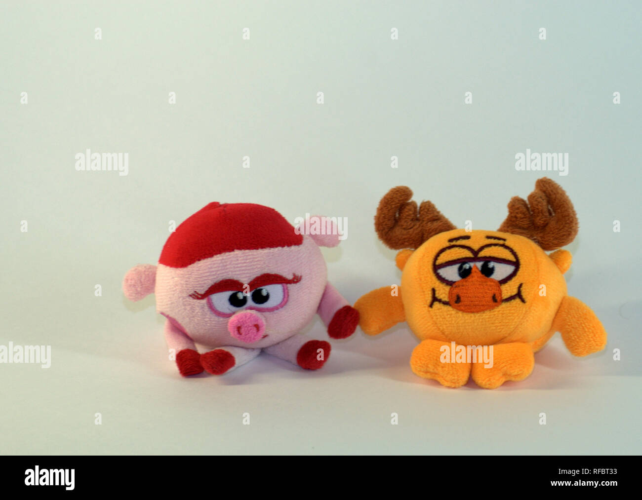 Small soft children's toys depicting a baby pig and moose. The picture ...