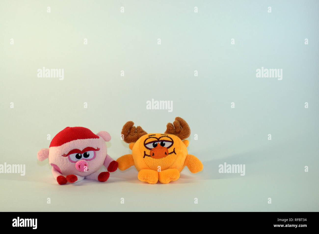 Small soft children's toys depicting a baby pig and moose. The picture ...