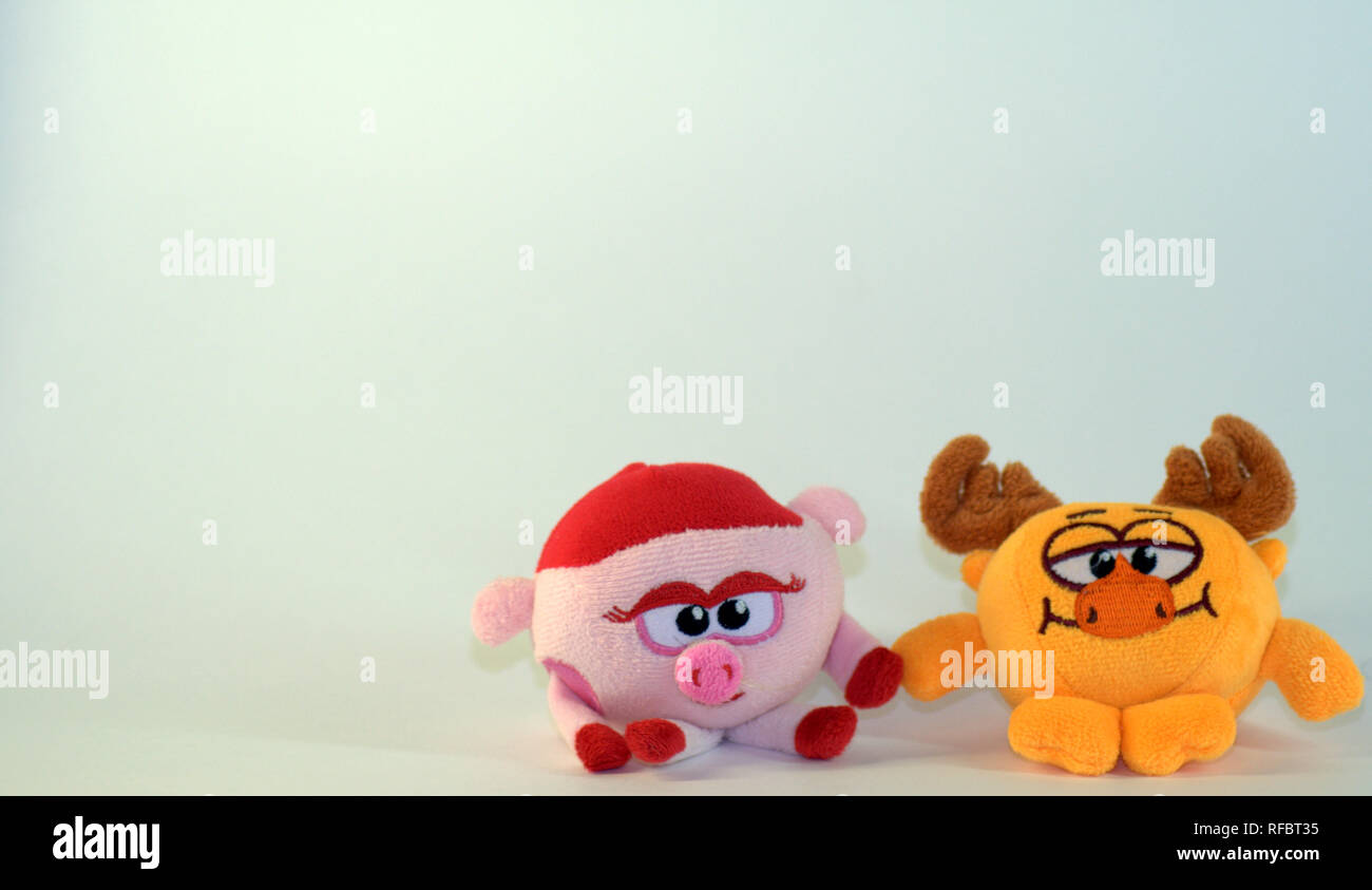 Small soft children's toys depicting a baby pig and moose. The picture ...