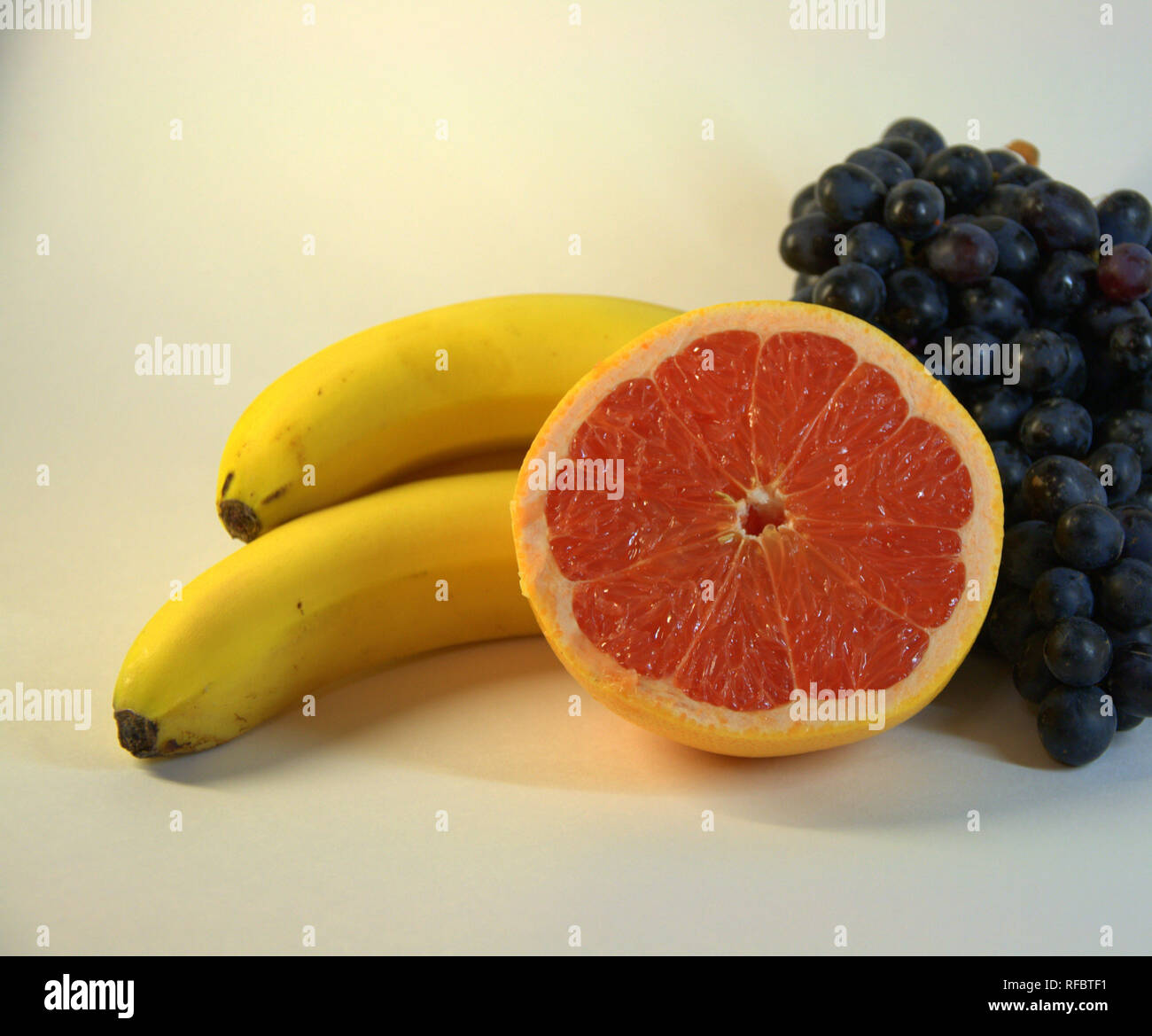 A bunch of ripe, tasty bananas, three pieces, a bunch of grapes and ...