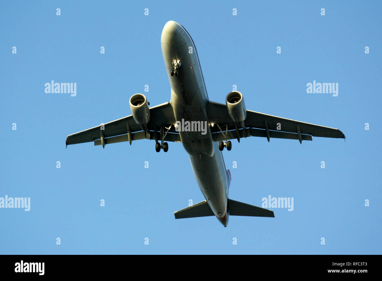 An airplane flies in the sky Stock Photo - Alamy