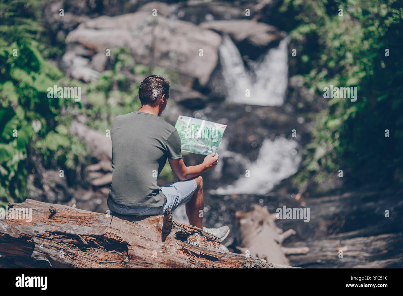 Tourist man with map in mountains in the background of beautiful ...