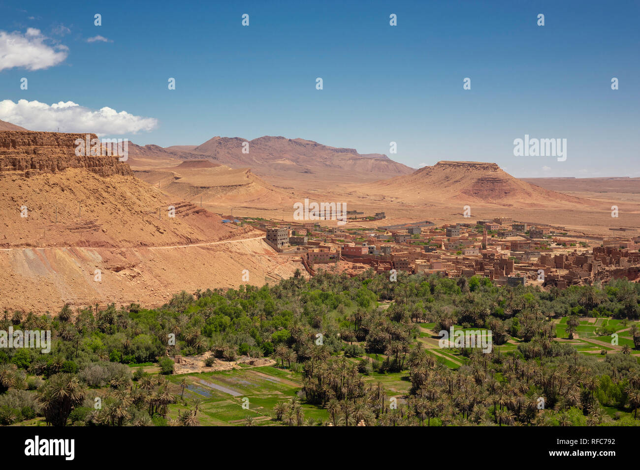 Old town of Tinghir, green palm oasis and rocky Atlas Mountains range ...