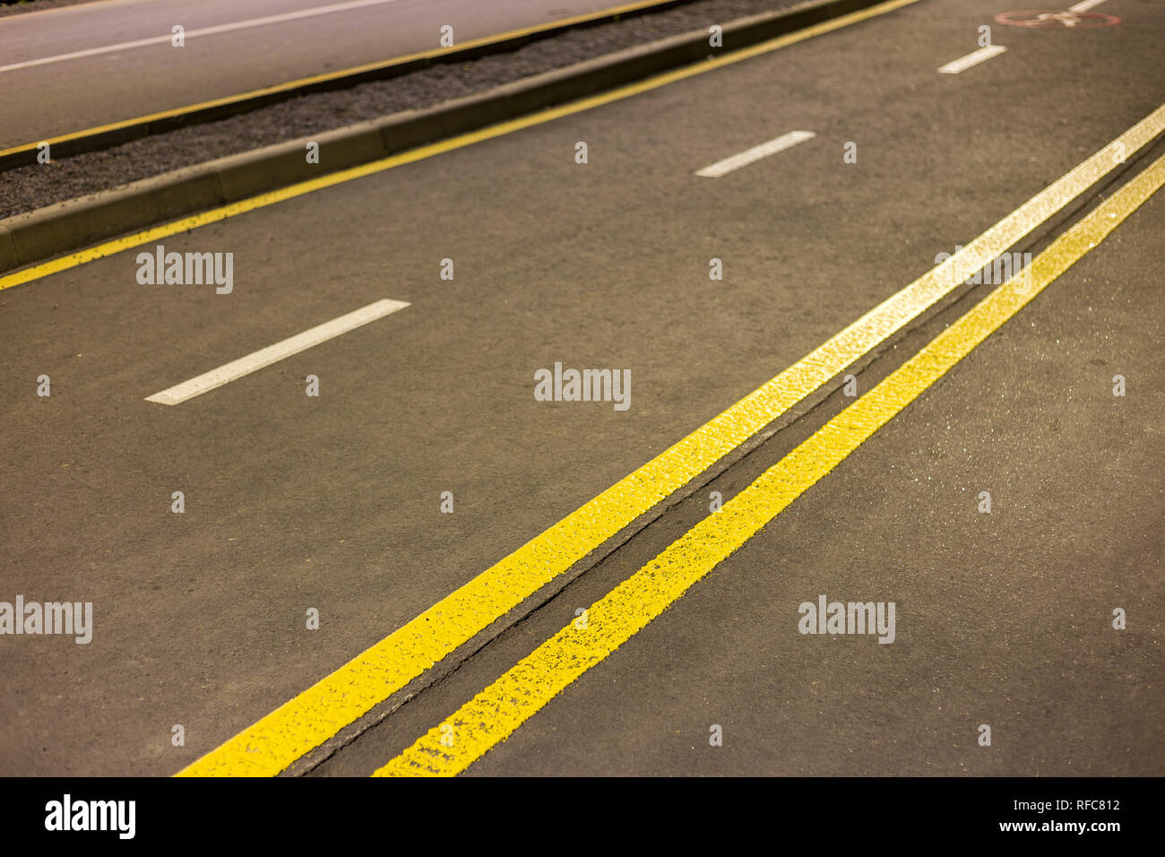 Wide bright double yellow marking sign line along modern wide smooth ...