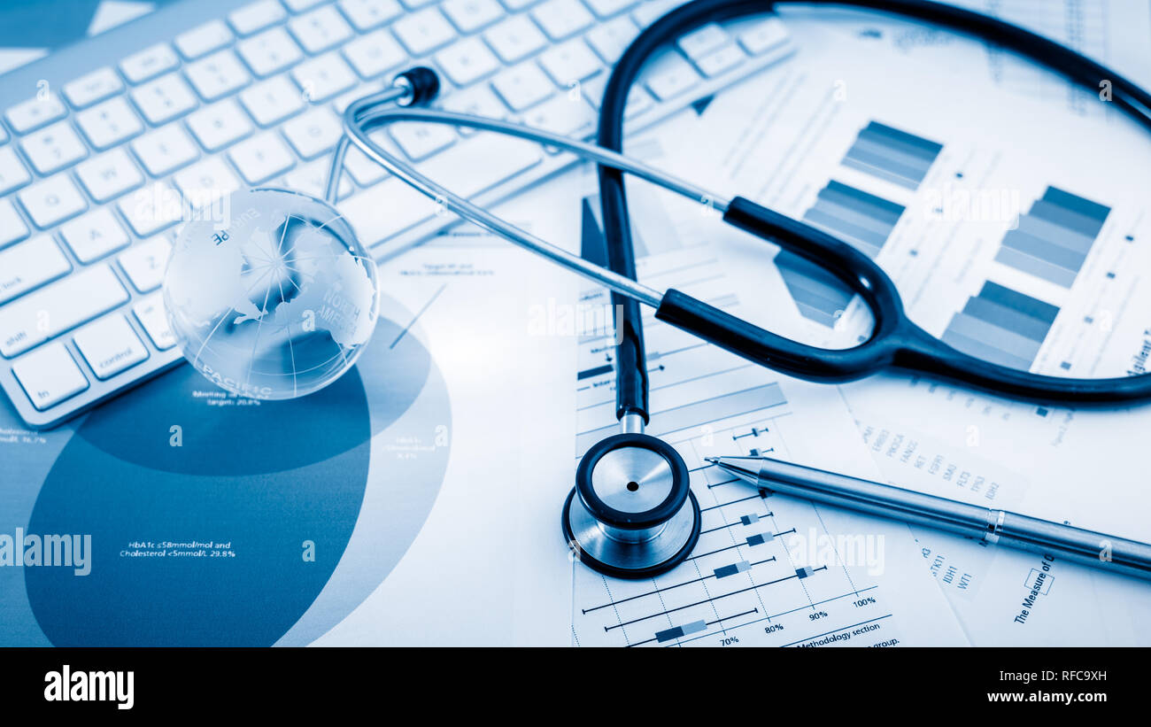 Stethoscope with financial on the desk Stock Photo - Alamy
