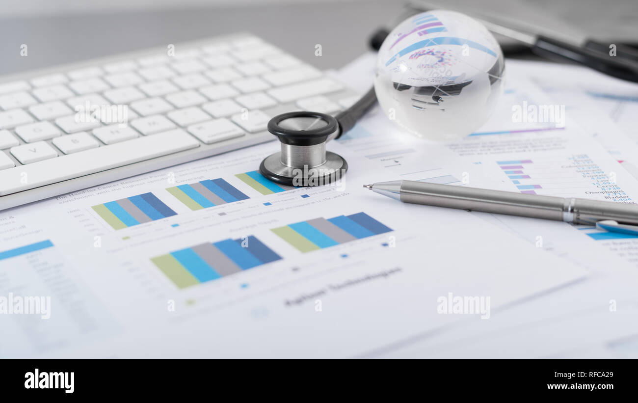 Stethoscope with financial on the desk Stock Photo - Alamy