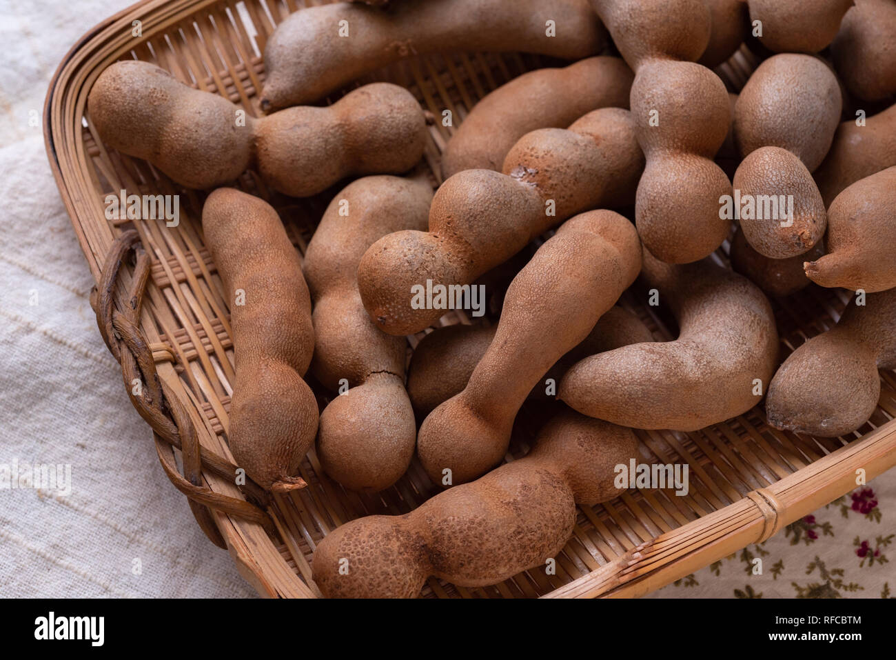 Tamarind in wicker basket Stock Photo - Alamy