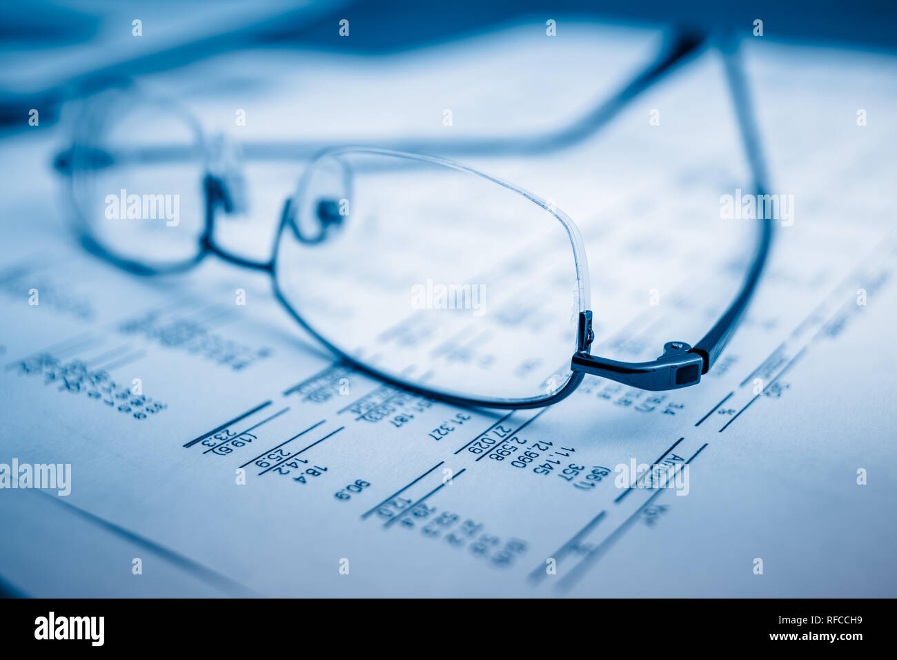 glasses on the finance chart on the desk Stock Photo - Alamy