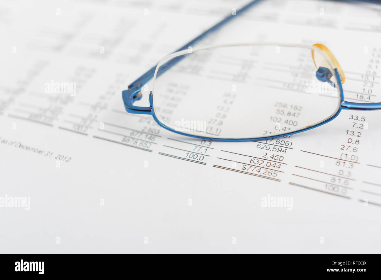 glasses on the finance chart on the desk Stock Photo - Alamy