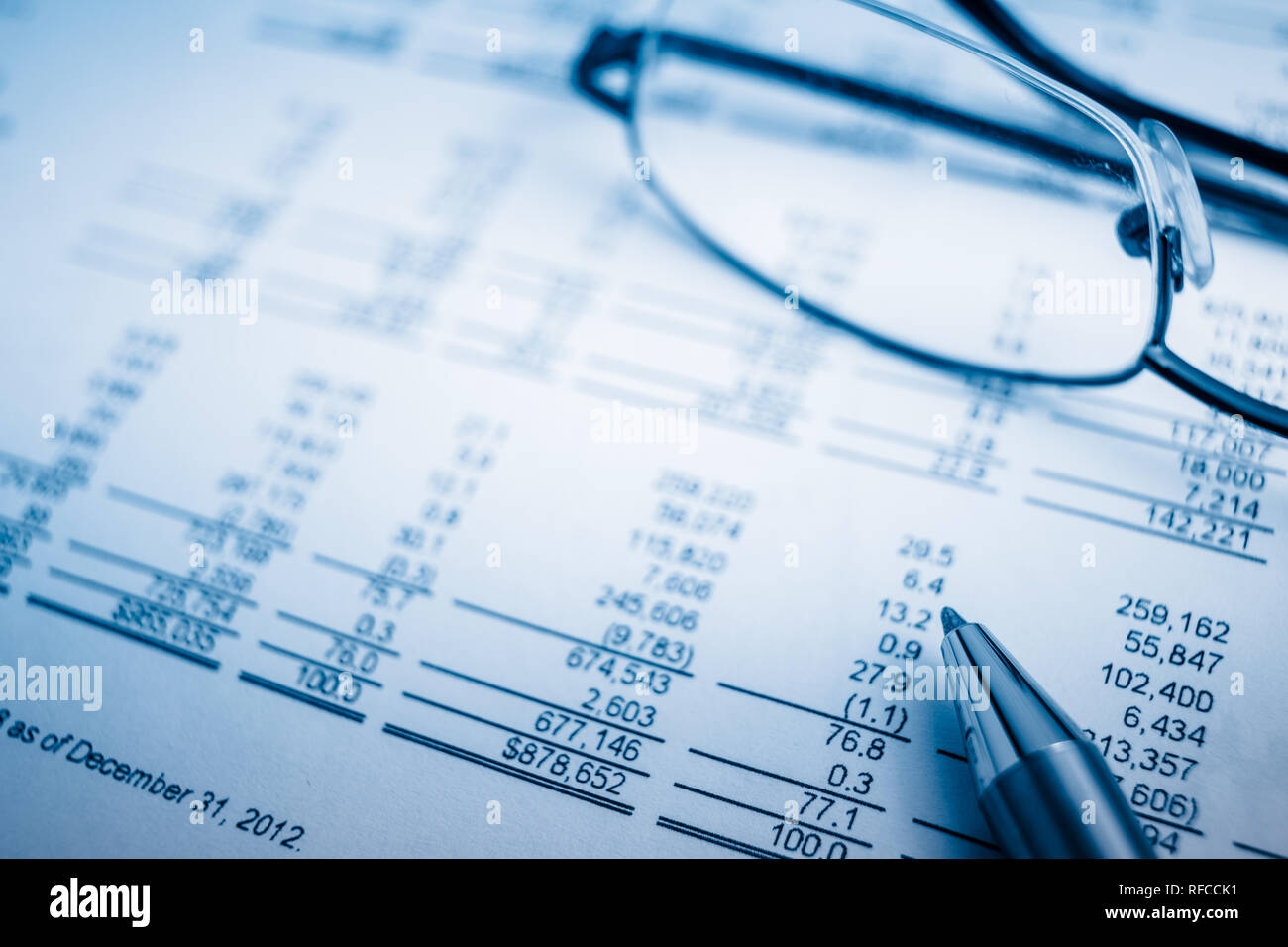 glasses on the finance chart on the desk Stock Photo - Alamy