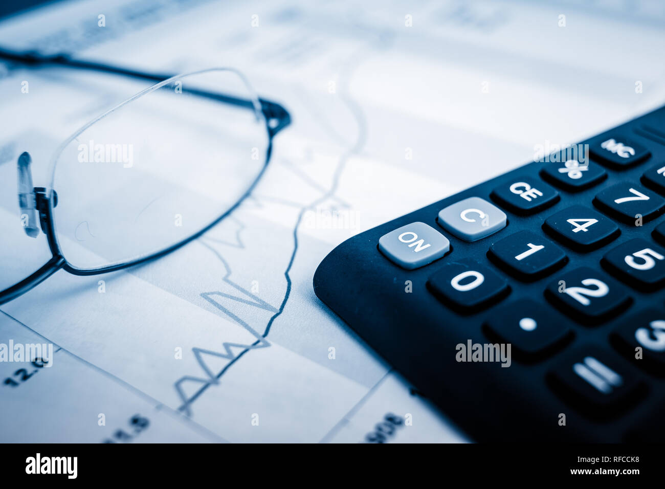 glasses on the finance chart on the desk Stock Photo - Alamy