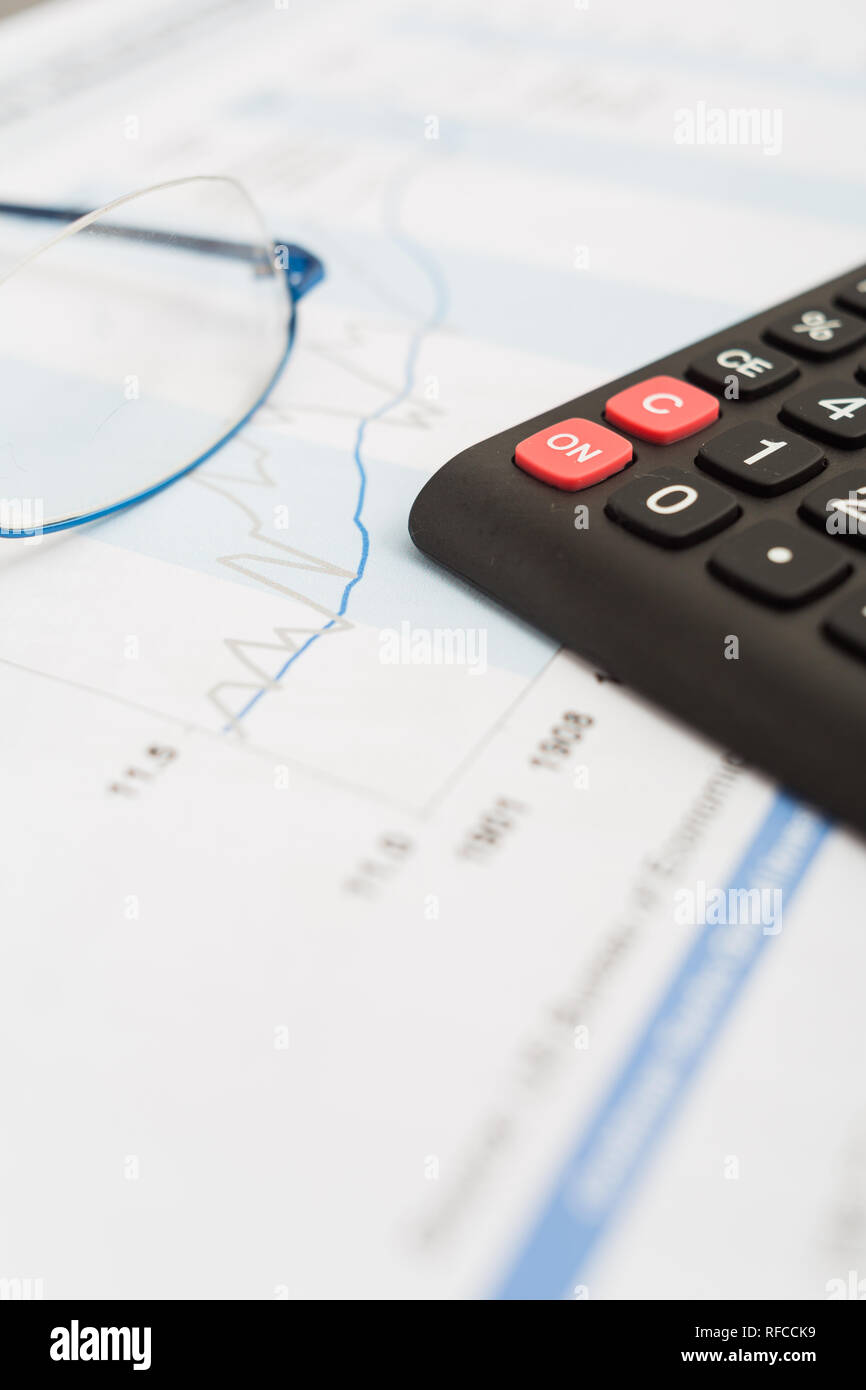 glasses on the finance chart on the desk Stock Photo - Alamy