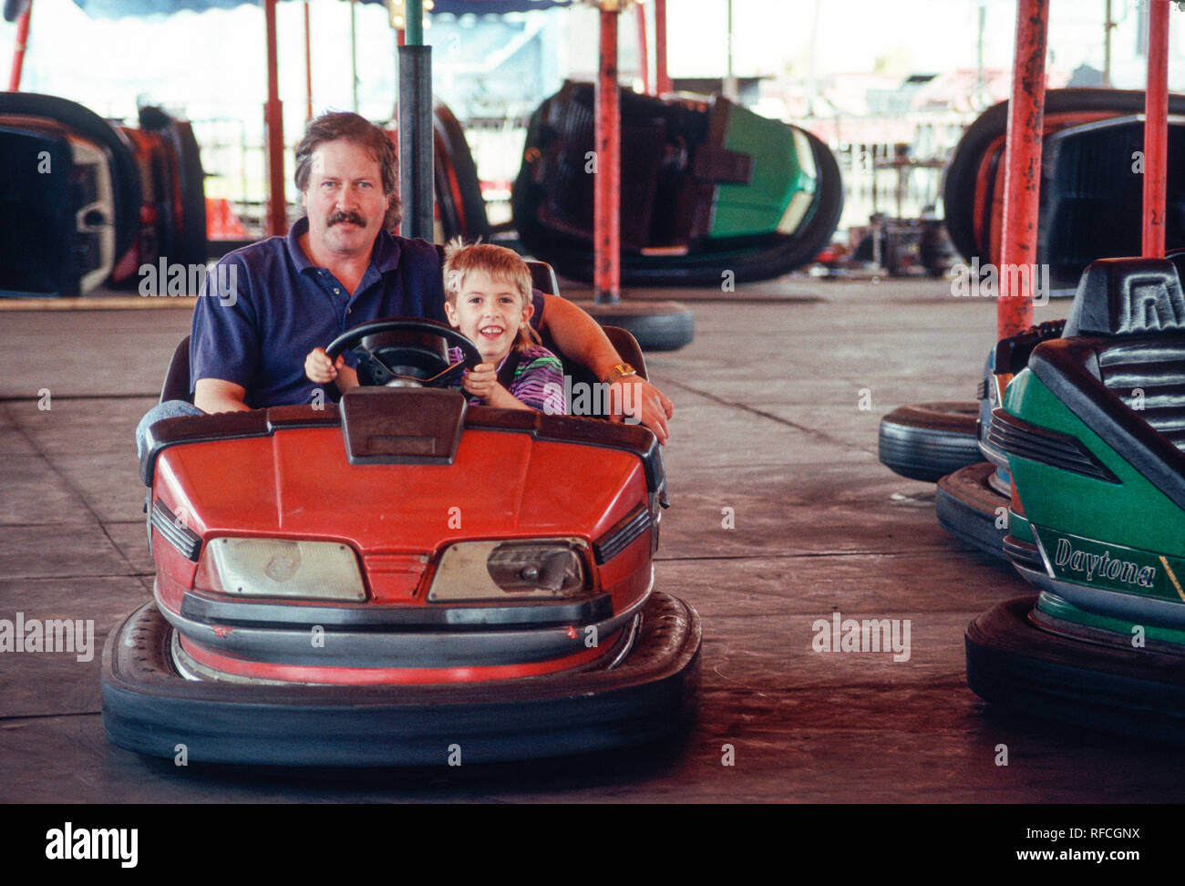 Father and His Young Son Enjoy a Bumper Car Ride at a County Fair, USA ...