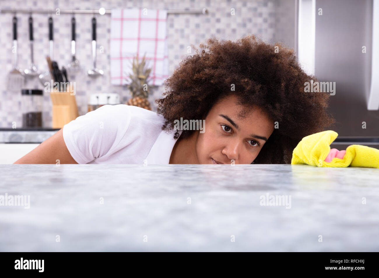 Happy African Young Woman Cleaning Dirty Kitchen Counter With Spray ...