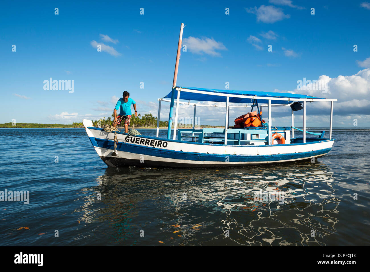 BAHIA, BRAZIL - FEBRUARY, 2016: A boat captain gets ready to throw the ...