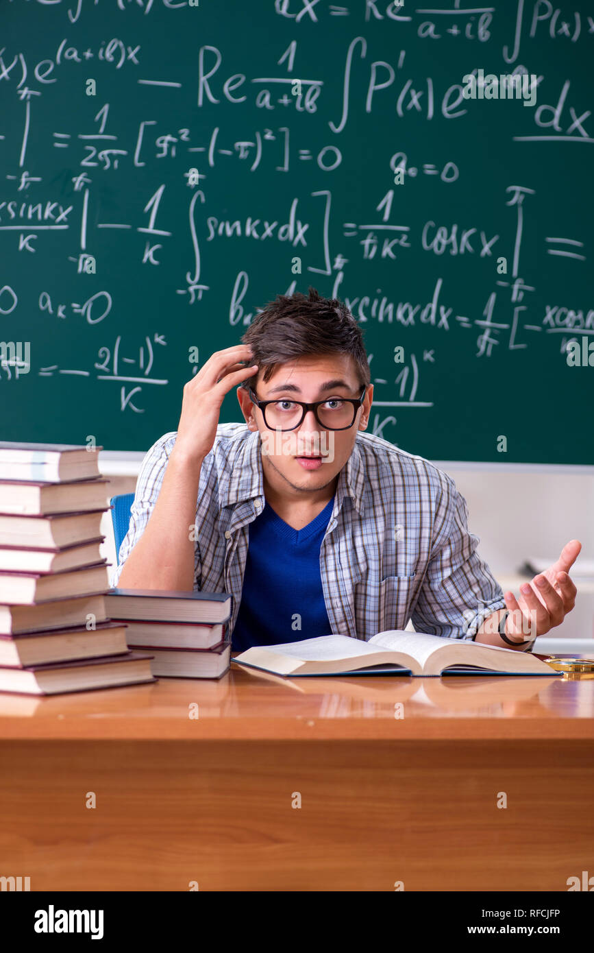 Young male student studying math at school Stock Photo - Alamy