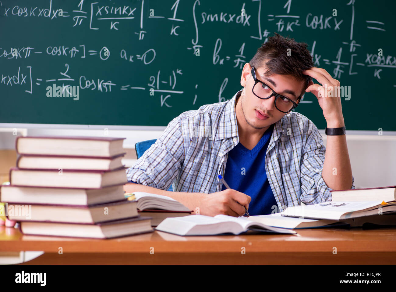 Young male student studying math at school Stock Photo - Alamy