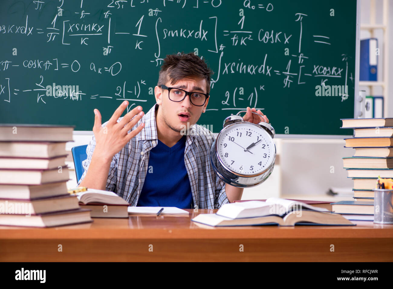 Young male student studying math at school Stock Photo - Alamy