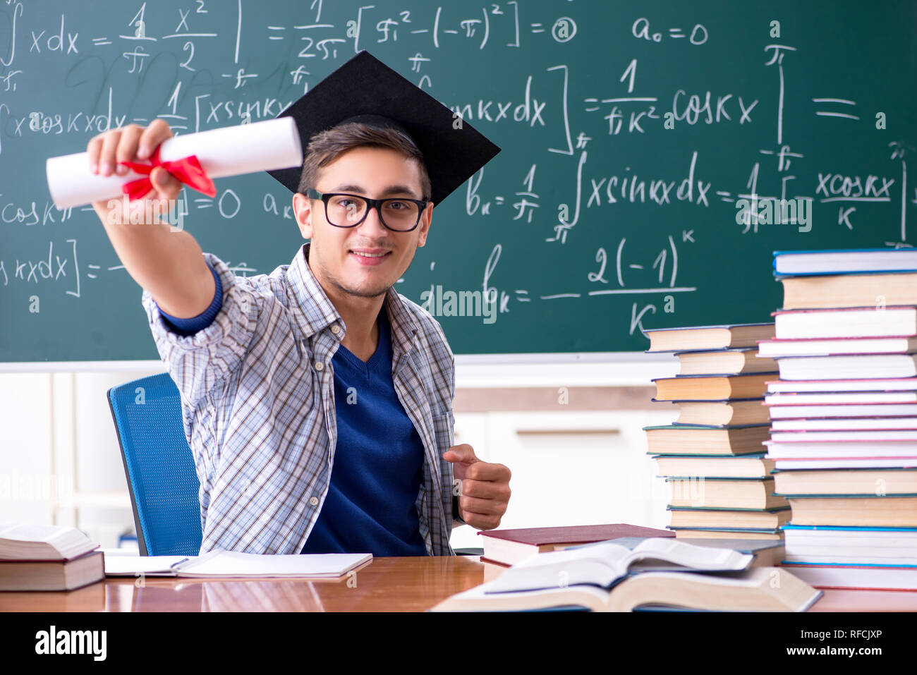 Young male student studying math at school Stock Photo - Alamy