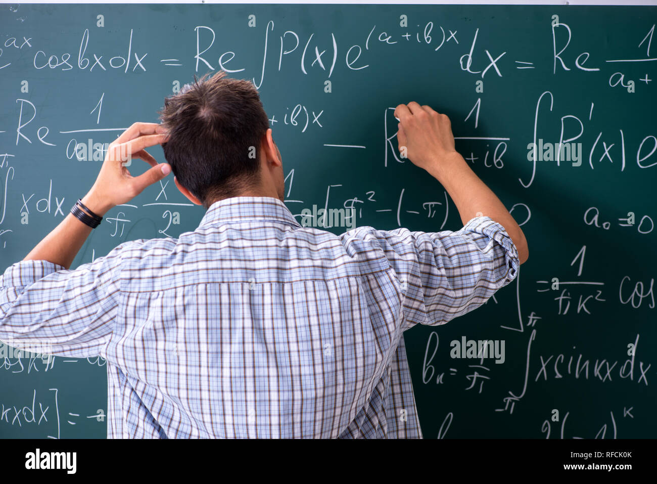 Young male student studying math at school Stock Photo - Alamy