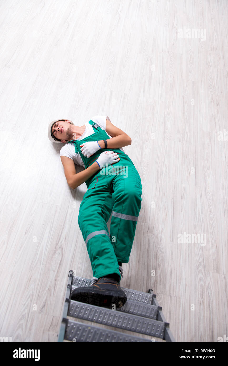 Young worker falling from the ladder Stock Photo - Alamy