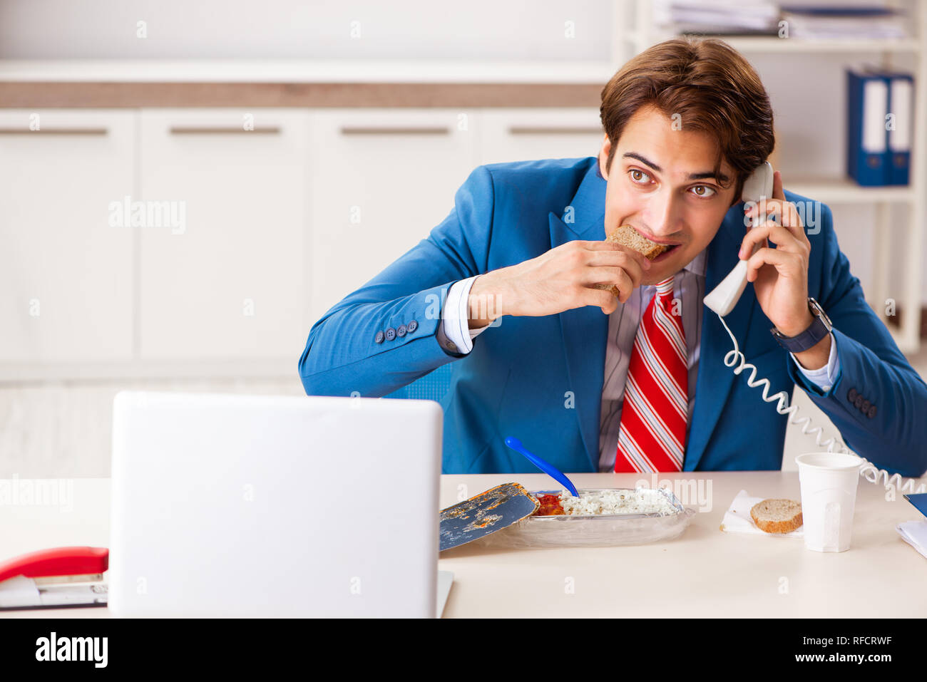 Man having meal at work during break Stock Photo - Alamy