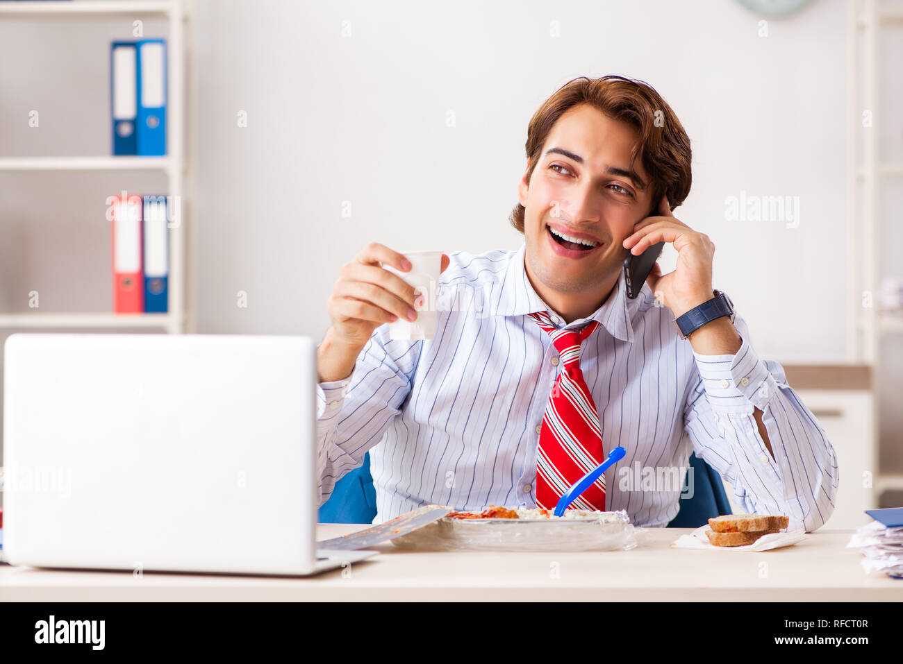 Man having meal at work during break Stock Photo - Alamy