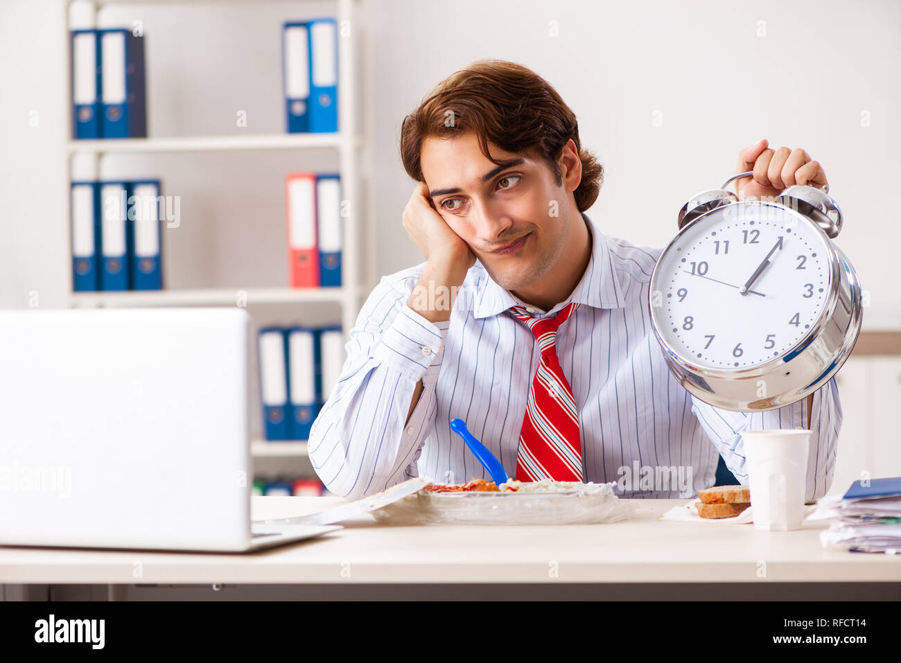 Man having meal at work during break Stock Photo - Alamy