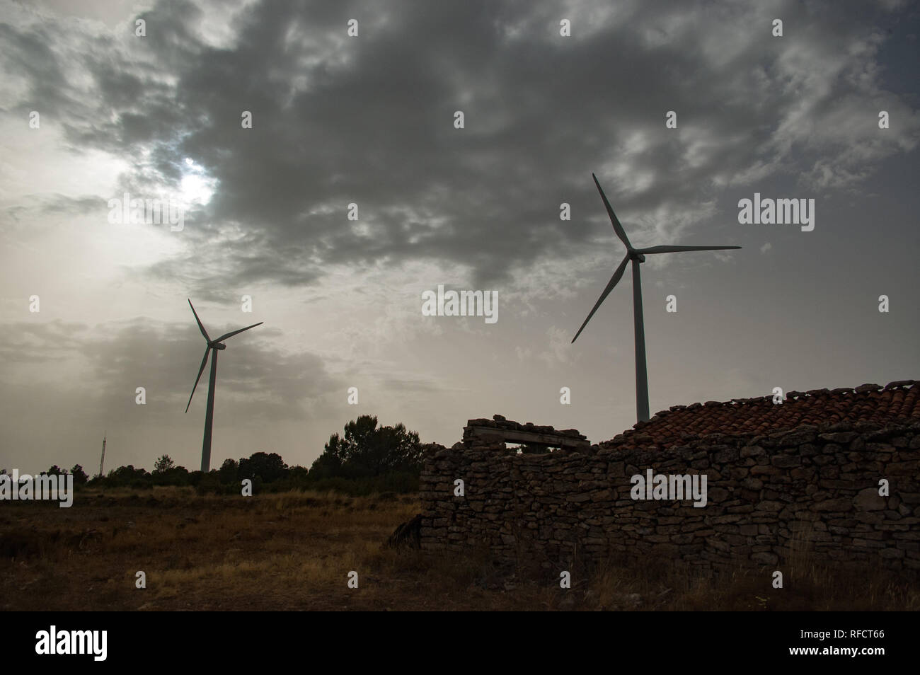 Two windmills near an old house with cloudy sky at countryside Stock ...
