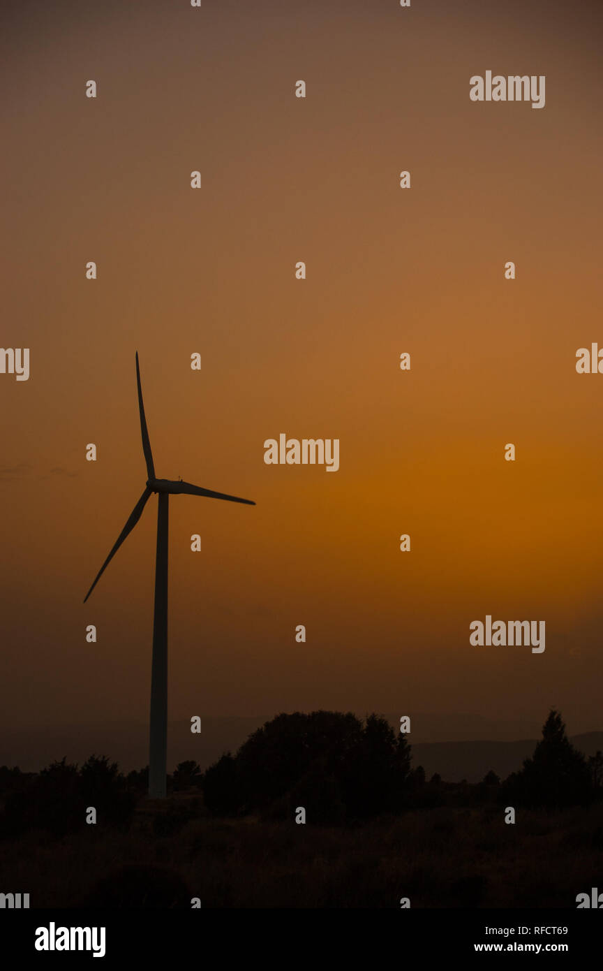 Orange sky and one windmill at countryside Stock Photo - Alamy