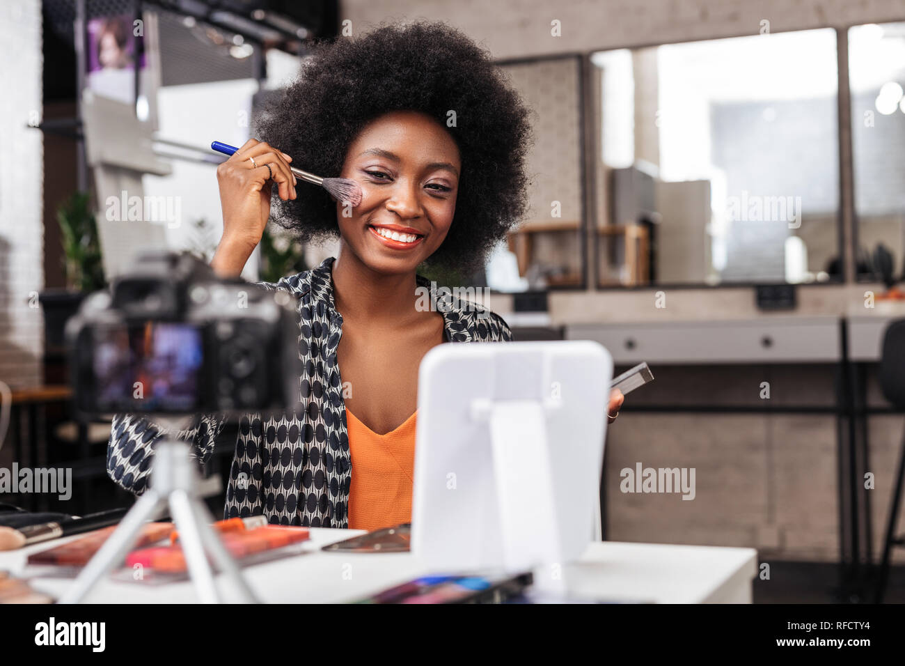 Positive dark-skinned woman with curly hair smiling brightly Stock ... Positive dark-skinned woman with curly hair smiling brightly Stock ...