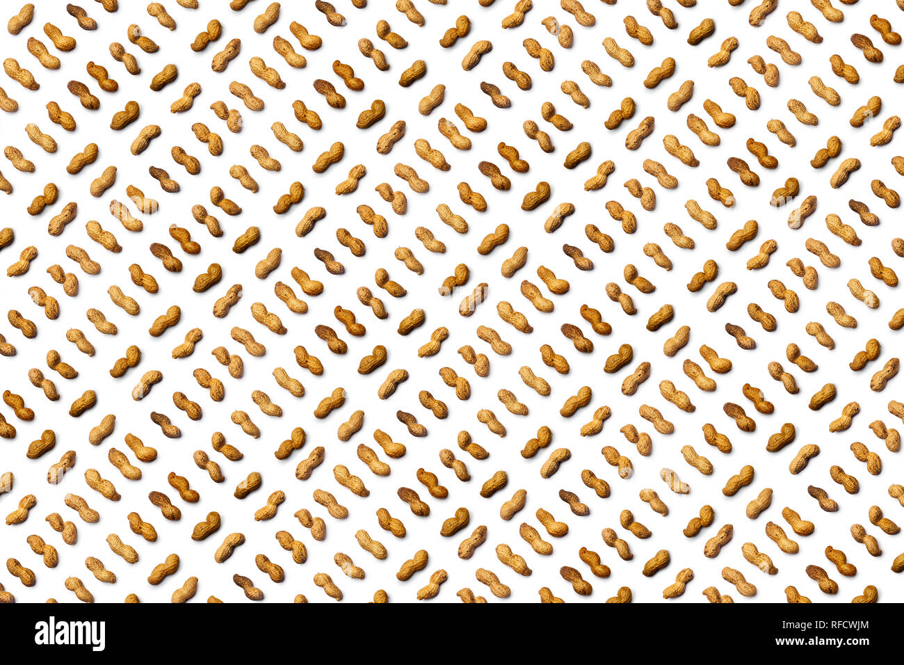 A collection of Unpeeled peanuts lie in straight rows along dioganals ...