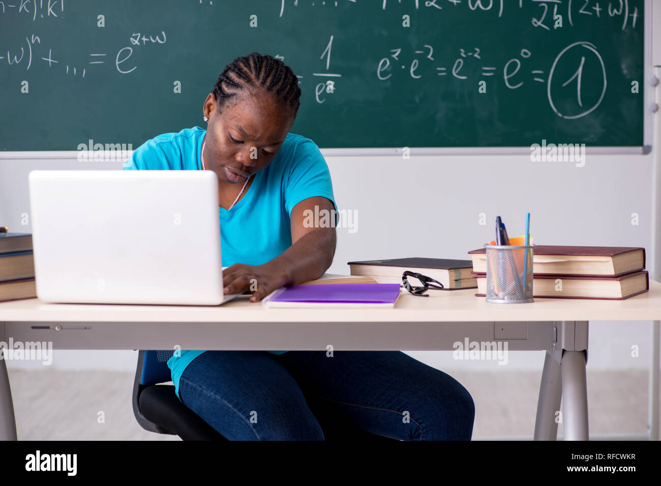 Black female student in front of chalkboard Stock Photo - Alamy