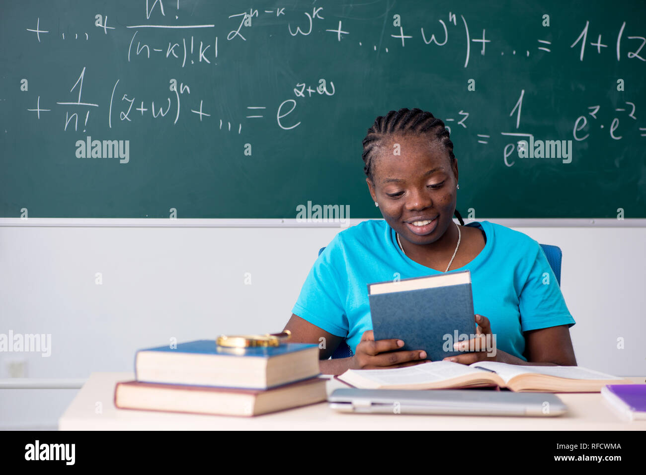 Black female student in front of chalkboard Stock Photo - Alamy