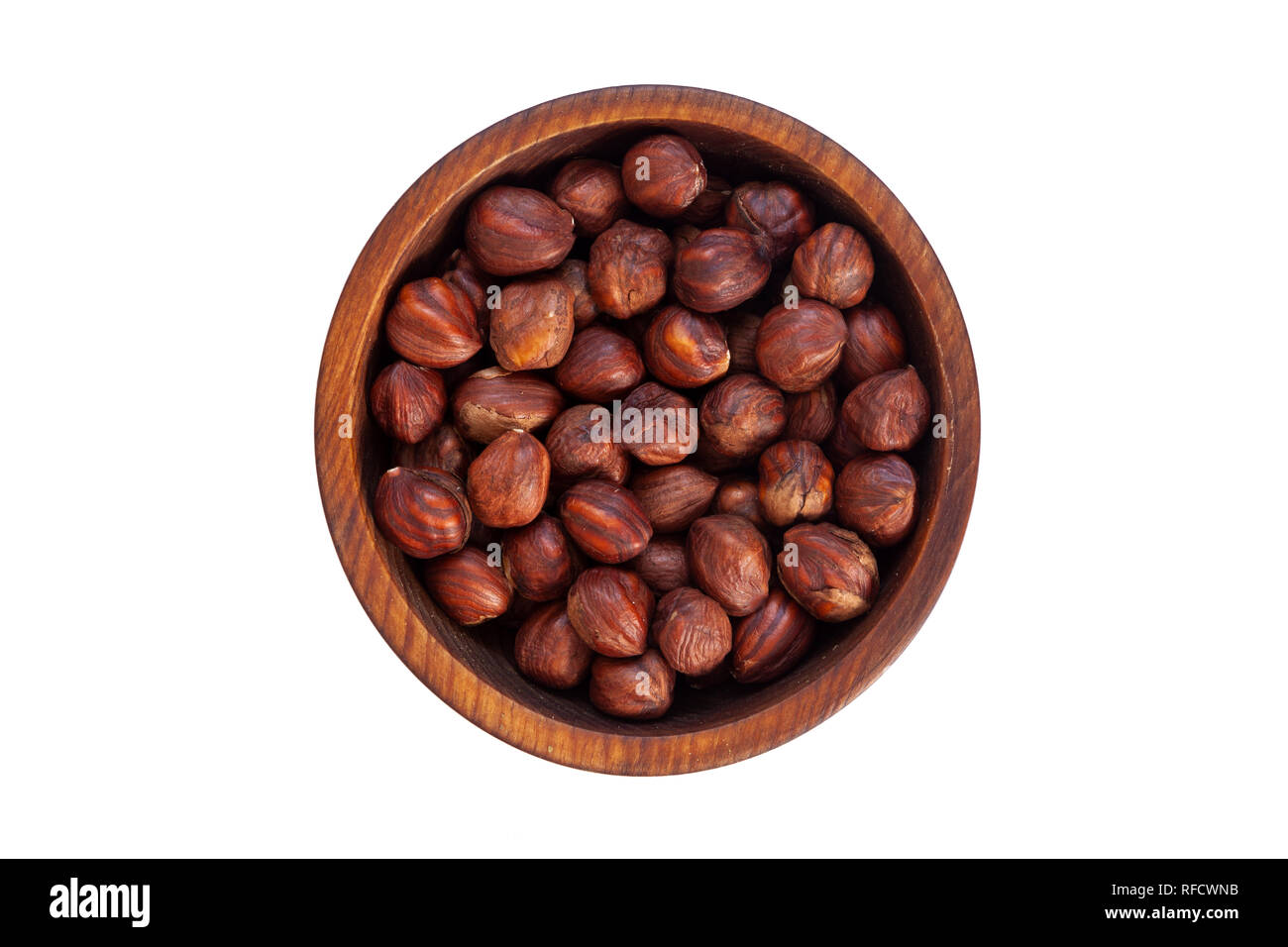 Peeled hazelnut in a wooden cedar plate on a white isolated background ...