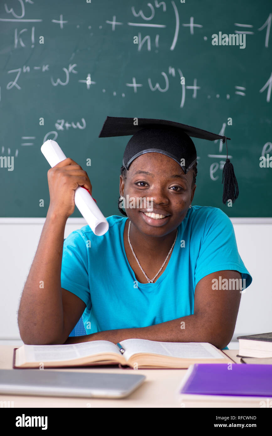 Black female student in front of chalkboard Stock Photo - Alamy