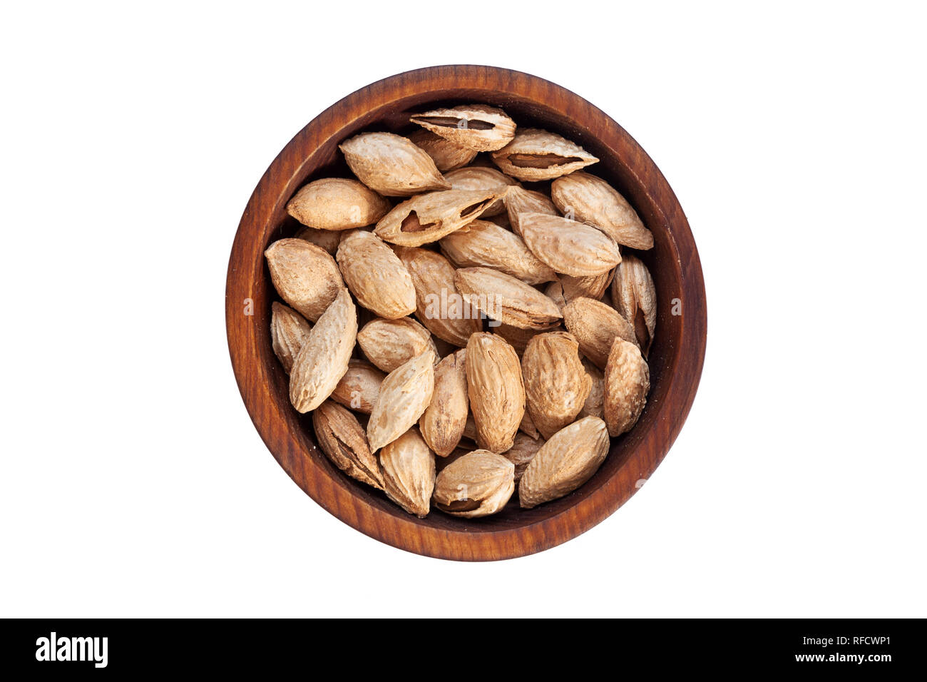 Unpeeled almonds Badam in a wooden cedar plate on a white isolated ...