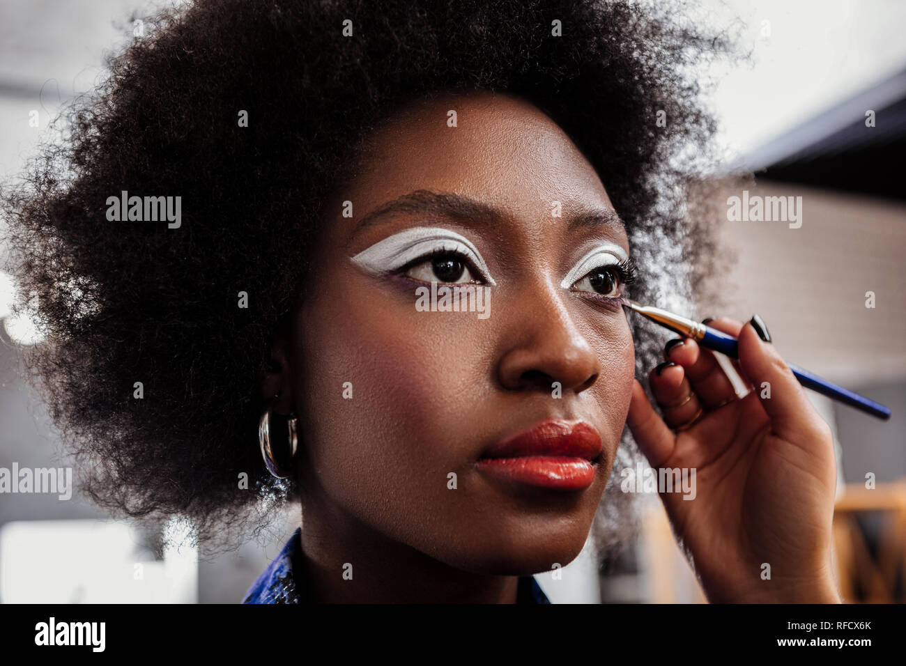 Dark-skinned african american model with bright eyeshadows looking ...