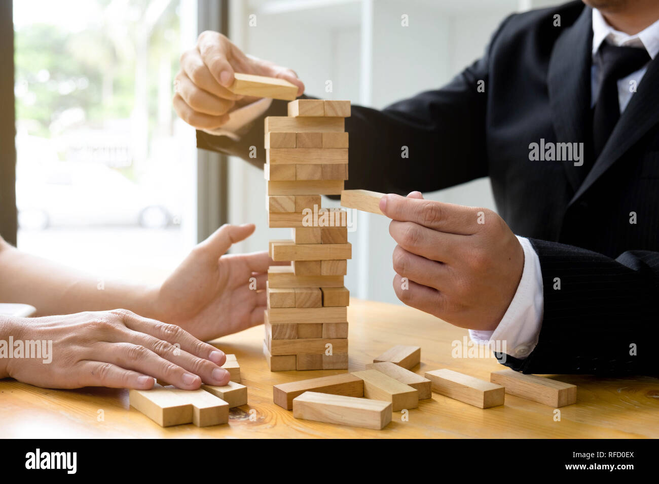 Businessmen picking domino blocks to fill the missing dominos and ...