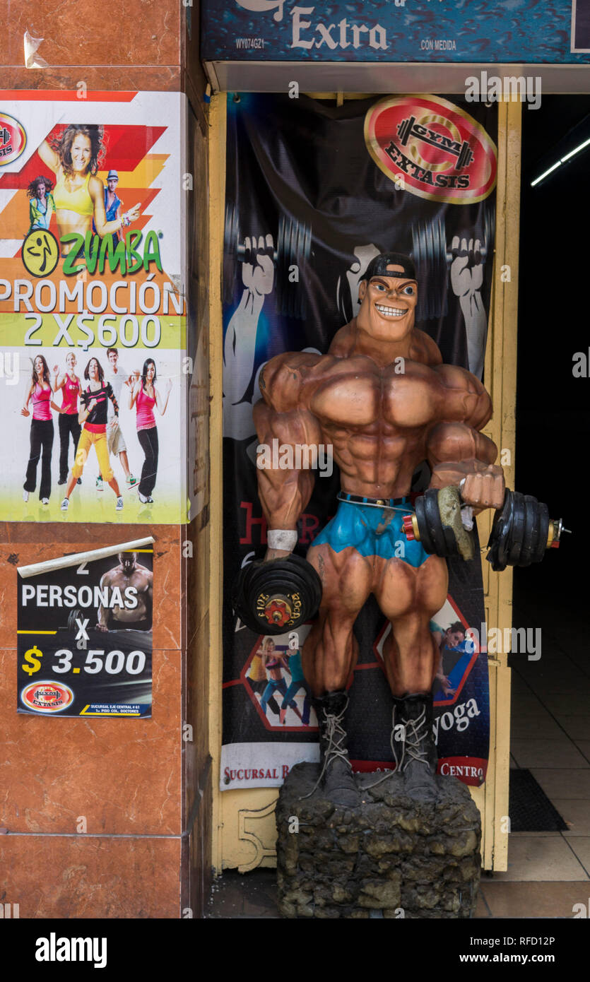 Exterior of a gym in Mexico City. Exterior has a mannequin of a ...